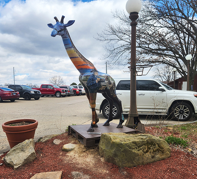 The whimsical painted giraffe statue stands guard in the parking lot, a quirky landmark that's become the unofficial greeter for hungry travelers.