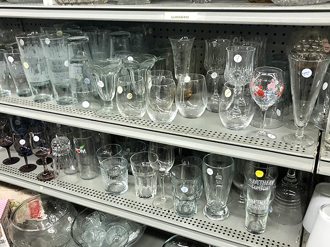 Crystal and glassware sparkle under fluorescent lights, ready to elevate any dining room table setting.