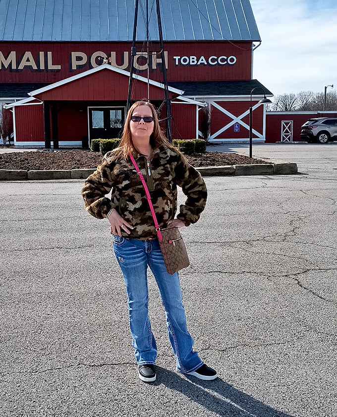 A woman proudly stands before her conquest. The barn behind her has no idea what delicious fate awaits inside.