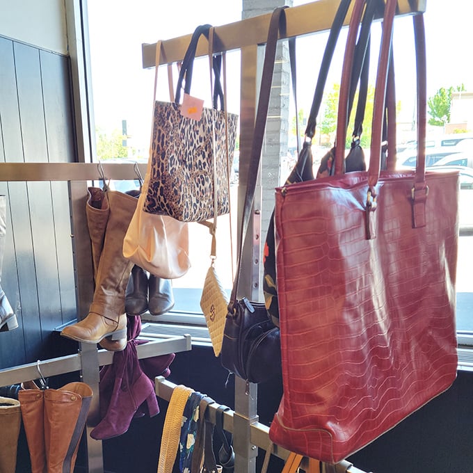 Designer handbags hanging patiently, their previous lives in upscale boutiques giving way to new adventures with savvy shoppers.
