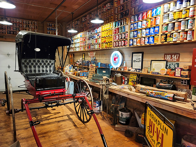 This vintage carriage sits amid a treasure trove of automotive memorabilia, including enough oil cans to lubricate every squeaky hinge in the Midwest. 