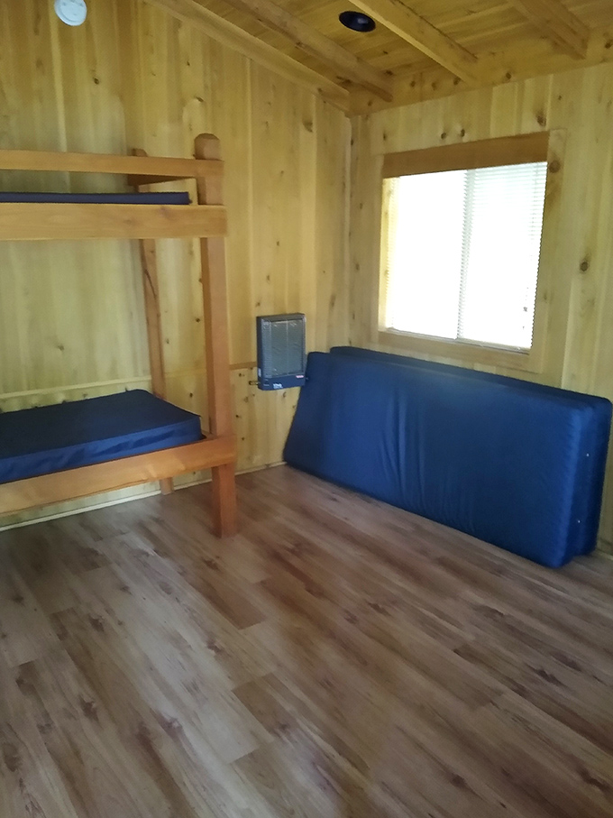 Inside the park cabins, rustic comfort awaits weary hikers. Blue mattresses have never looked so inviting after a day on the trails.