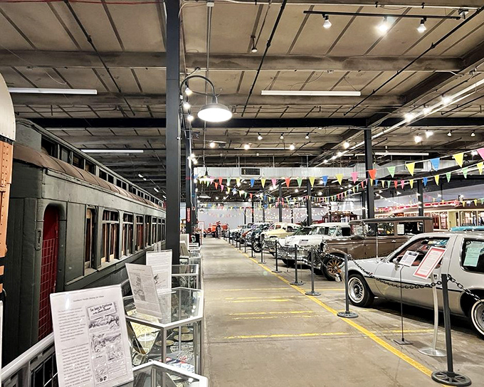 Colorful pennants hang above a parade of vintage automobiles, creating the atmosphere of the world's most impressive and educational used car lot.