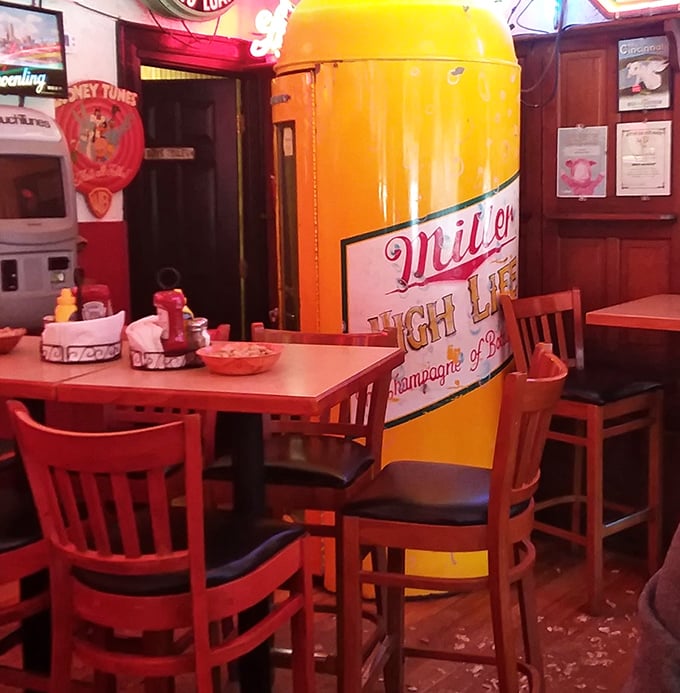 Every inch of wall and ceiling space tells a story, creating an atmosphere where memories are made between bites of legendary burgers.