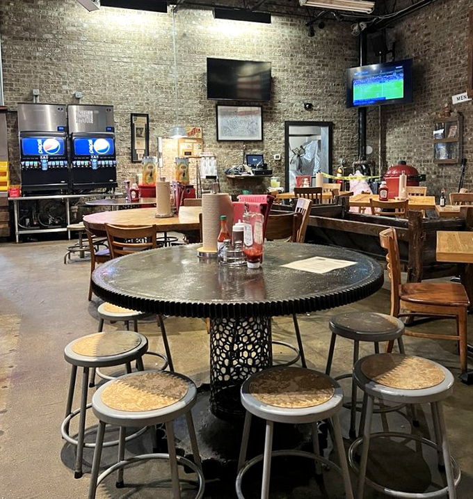 Industrial meets rustic in this dining space where brick walls have absorbed decades of smoky conversations and satisfied sighs.