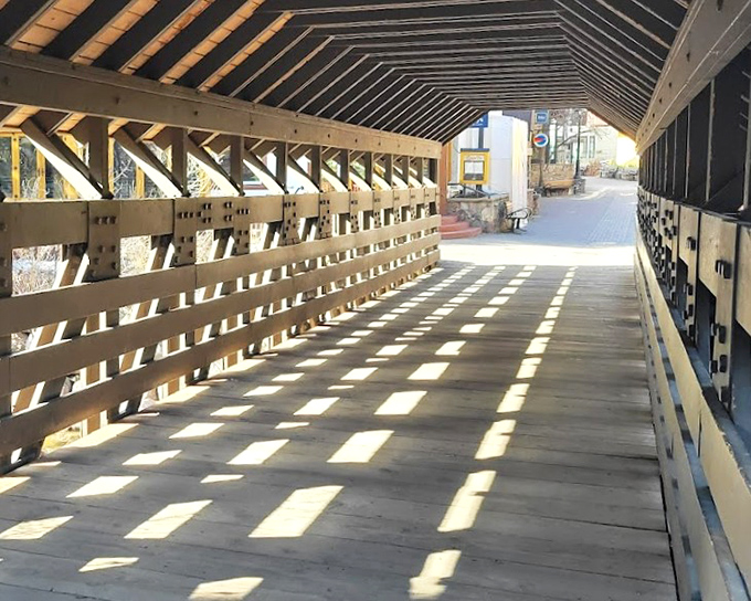 Sunlight plays tic-tac-toe on the wooden planks, creating patterns that change throughout the day&mdash;nature's own light show.