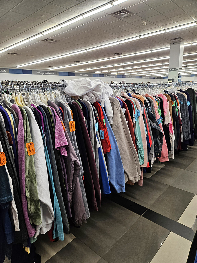 The rainbow rack of jackets and sweaters where winter preparation meets budget-friendly fashion in a glorious textile tapestry.