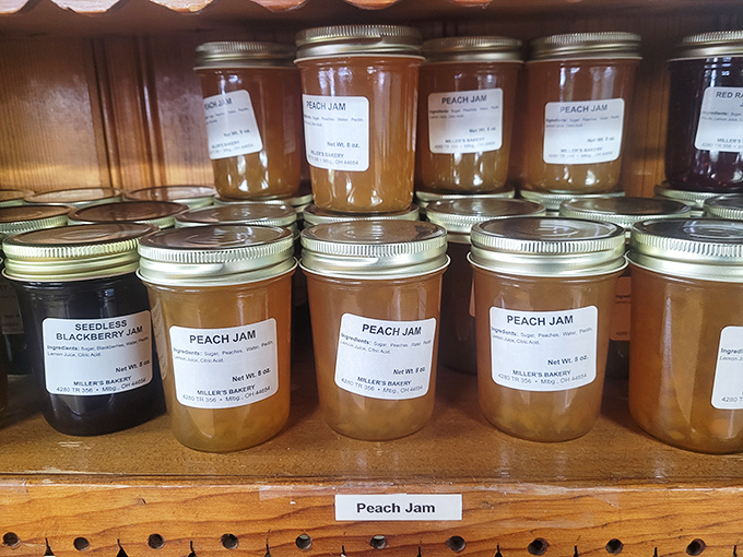 Homemade jams lined up like edible jewels&mdash;summer's bounty captured in glass. Each jar contains sunshine, fruit, and the patience only small-batch production allows.
