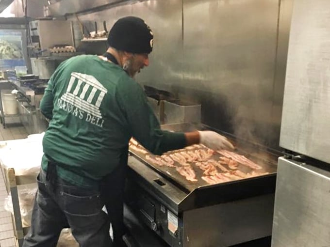 Behind the scenes, culinary magic happens on the flattop grill. Every sizzle and scrape brings another perfect sandwich closer to reality.