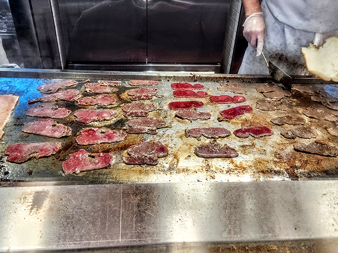 The sacred grill where magic happens. Those thin slices of beef aren't just cooking&mdash;they're transforming into Philadelphia's edible heritage.