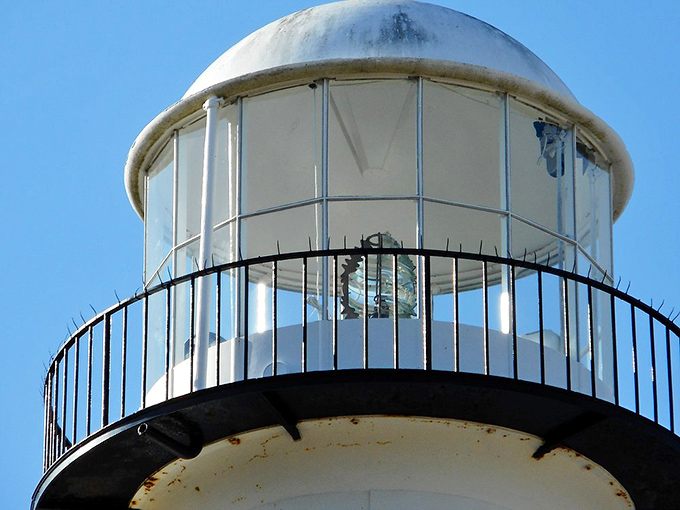 The lantern room's glass panels have witnessed countless sunrises while guiding mariners safely to Mississippi's shores.
