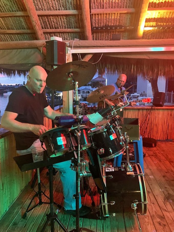 Live music under the palms. These musicians create the soundtrack to your perfect Florida evening as boats drift by in the background.
