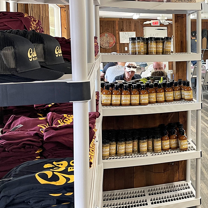 Branded merchandise and sauce bottles stand ready for adoption. Because wearing the t-shirt is the next best thing to having the brisket.