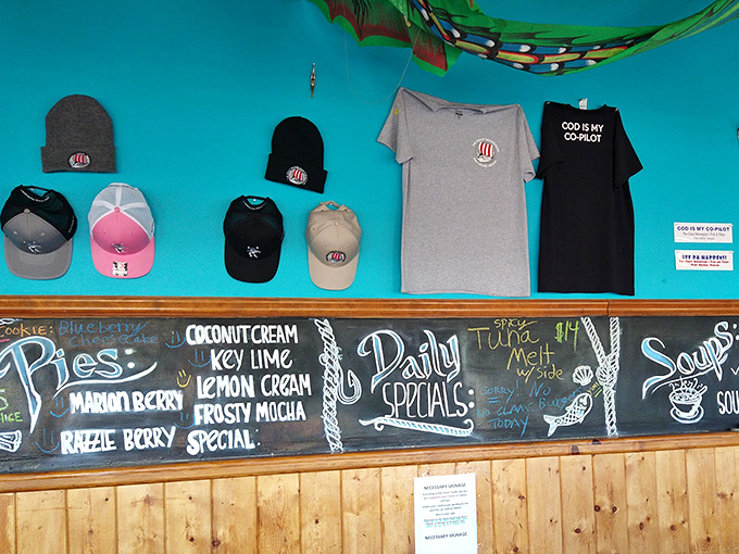 Merchandise and a chalkboard menu showcasing pie varieties that would make grandmothers jealous. Those hats say "I've eaten something legendary."