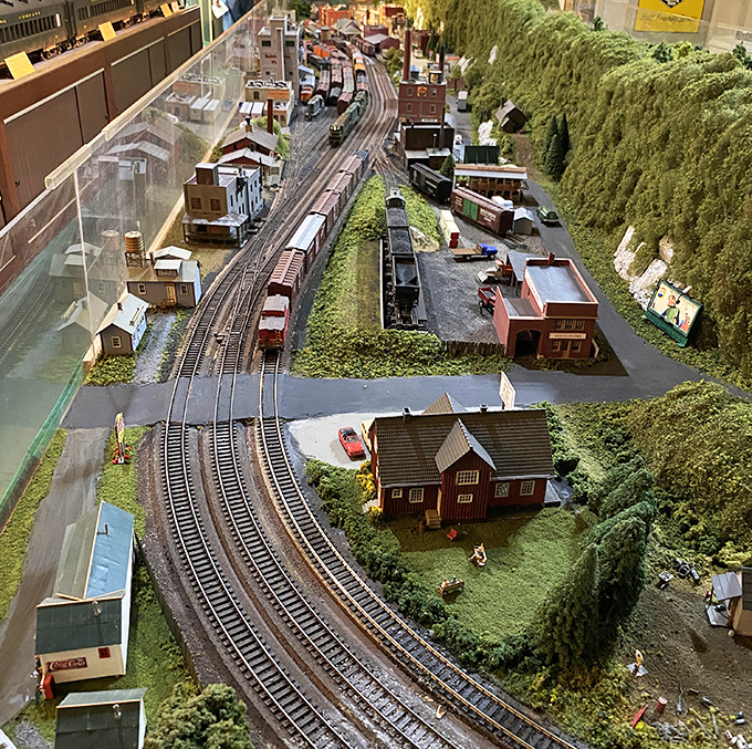 The meticulously crafted model railroad layout recreates a miniature world where tiny trains run forever on time through perfect Pennsylvania towns.