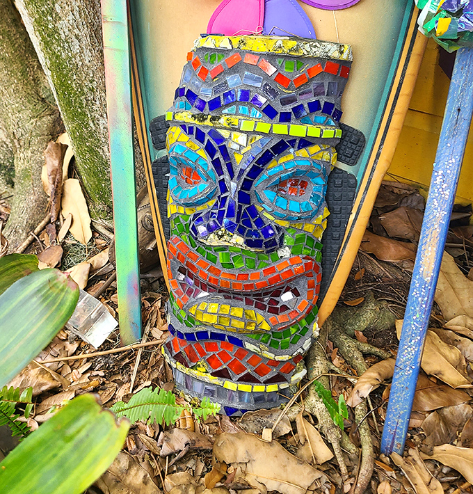 This mosaic tiki face has seen things. Its geometric grimace tells stories of thousands of visitors who've wandered these magical paths.