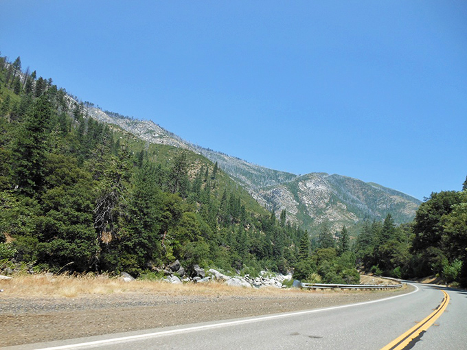 The winding road hugs mountainsides that have witnessed centuries of travelers passing through. These slopes have stories to tell.