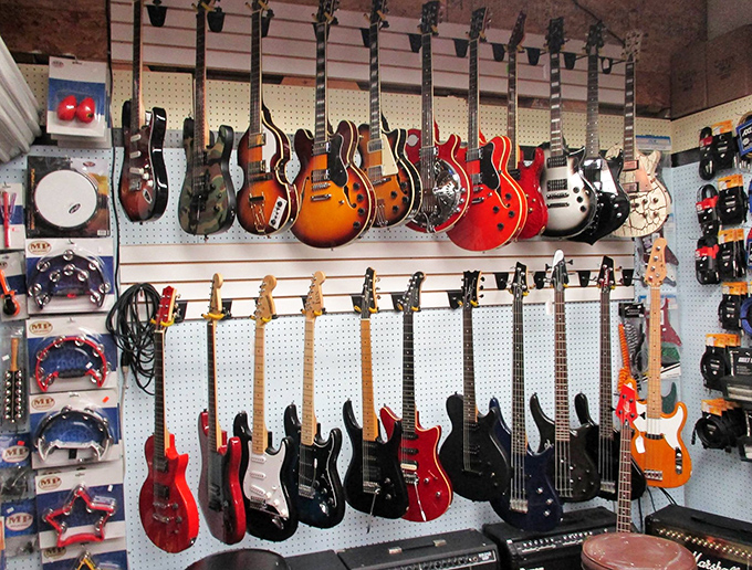 Electric guitars hanging like a rock and roll museum, waiting for someone to take them home and finally start that band.