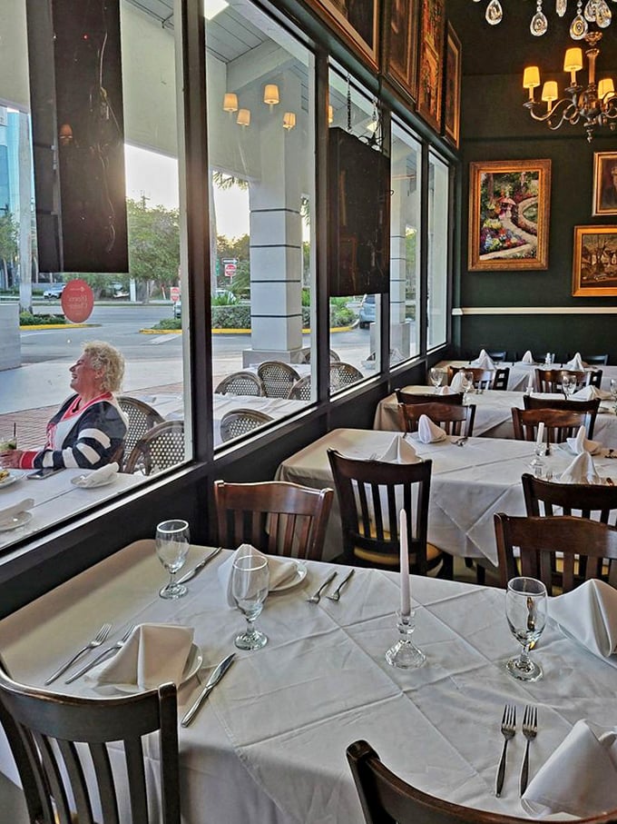 The view from inside: white tablecloths meet street-side charm. Where elegance and people-watching create the perfect dining duet.