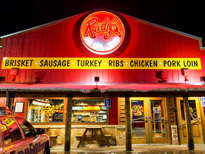 Rudy's at night, when the red glow beckons like a barbecue lighthouse guiding hungry ships to safe, delicious harbor.