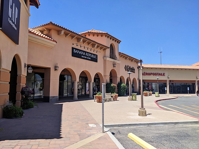 Spanish-inspired architecture housing Gap and Banana Republic. Desert shopping with Mediterranean flair.