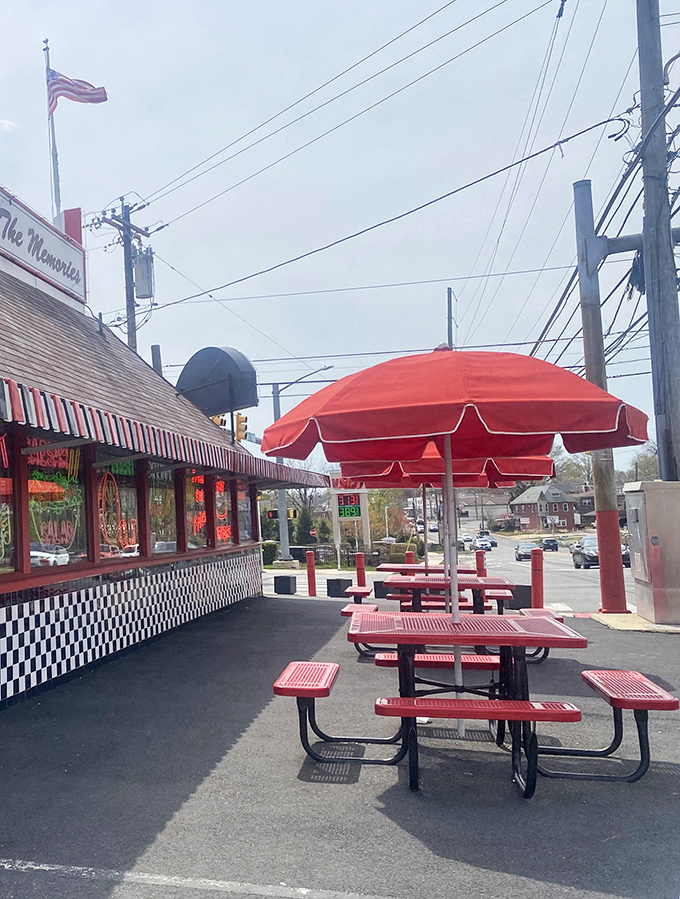 Outdoor seating under cheerful red umbrellas&mdash;because some burgers deserve fresh air and sunshine. The perfect spot for summer memories.