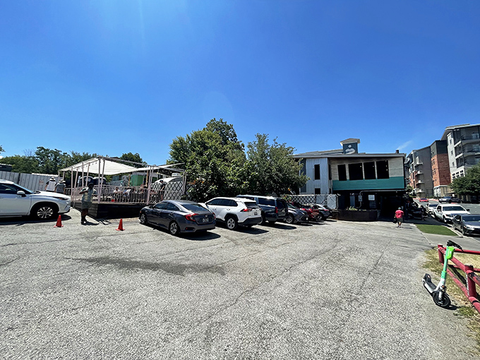 The promised land has a parking lot. Cars wait patiently while their owners join the pilgrimage to meat heaven.