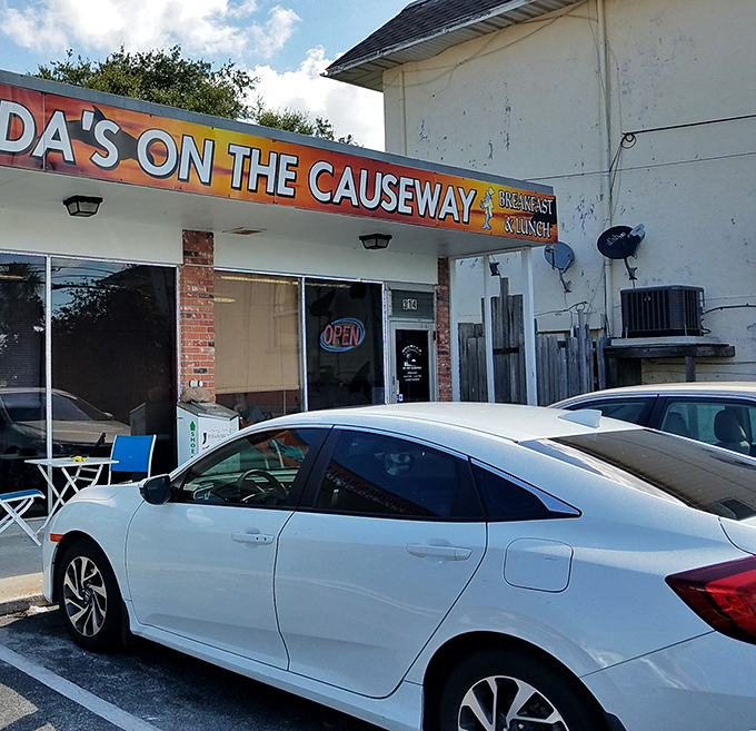 The parking lot view that locals recognize as the gateway to breakfast bliss. That "OPEN" sign never looked so inviting.