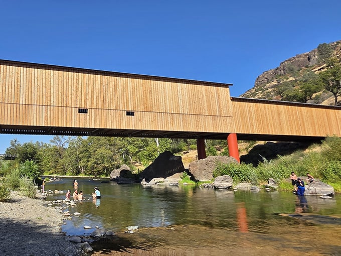 Summer's perfect playground&mdash;locals cool off in the creek beneath the bridge's watchful gaze. Some traditions never need updating.