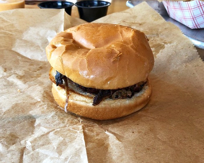 A pulled pork sandwich in its natural habitat: simple, unadorned, and absolutely perfect in its execution.