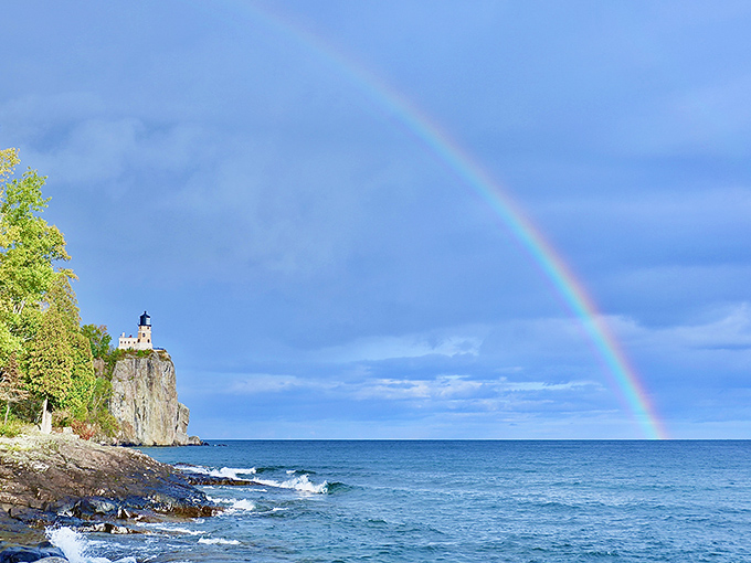 Nature's perfect photo op: a rainbow arches over Lake Superior with Split Rock in the distance. Even meteorological phenomena know where to pose here.