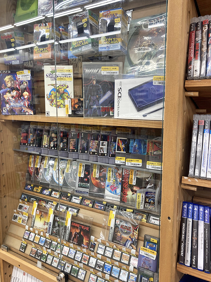 Retro gaming paradise behind glass, where yesterday's cutting-edge technology awaits collectors and nostalgia-seekers with yellow-stickered prices.
