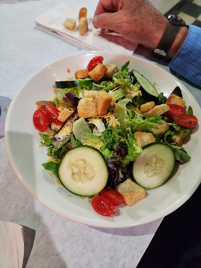 A salad that doesn't apologize for being healthy. Those fresh cucumbers and tomatoes are practically showing off their farmers market pedigree.