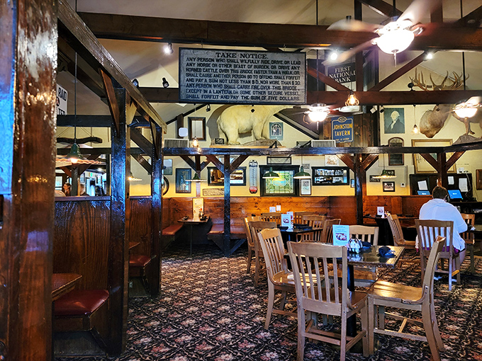 The dining room's rustic charm extends to every corner, with wooden beams, hunting trophies, and that carpet that's seen generations of happy diners.