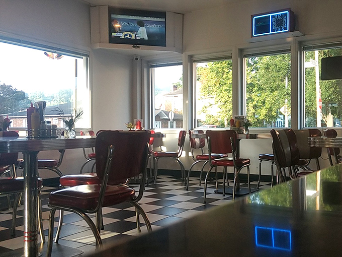 Sunlight streams through windows illuminating the classic diner seating. Each chair has a story, each table a thousand conversations. 