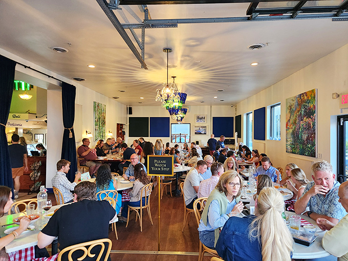 A bustling dining room filled with happy patrons &ndash; the universal language of "mmm" needs no translation here.