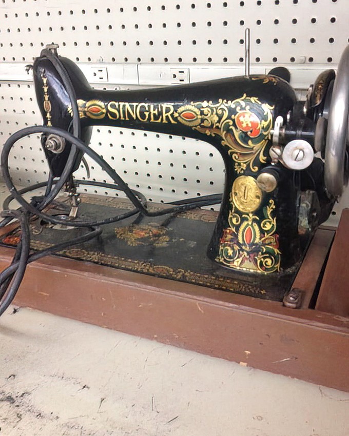 A vintage Singer sewing machine—ornate, beautiful, and possibly the star of someone's craft room renaissance for less than the cost of dinner out.