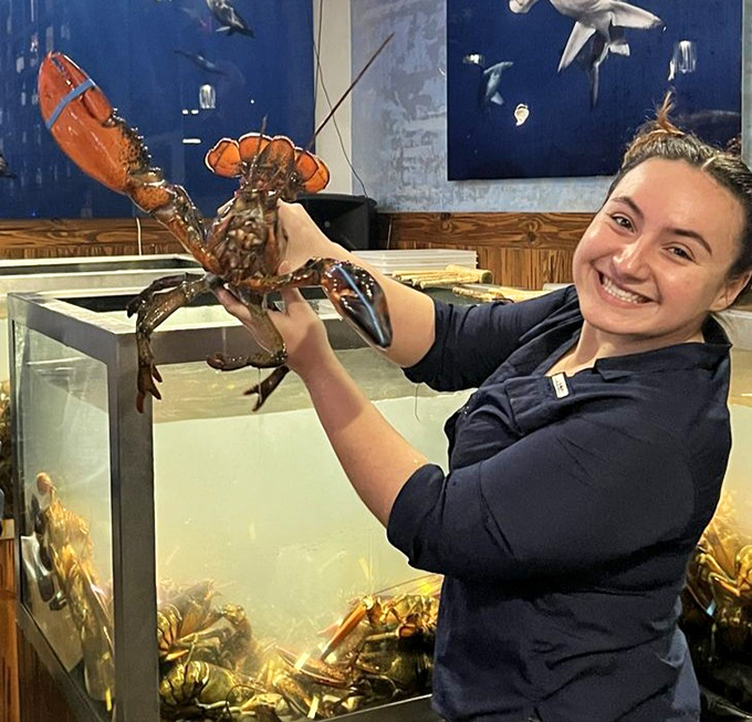 When your server holds a lobster with this much joy, you know you're in good hands. That smile isn't just customer service&mdash;it's the pride of someone who knows what deliciousness awaits you.