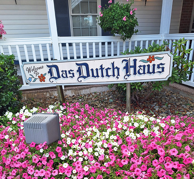 A welcome sign surrounded by flowers&mdash;because even the landscaping here shows they care about details.