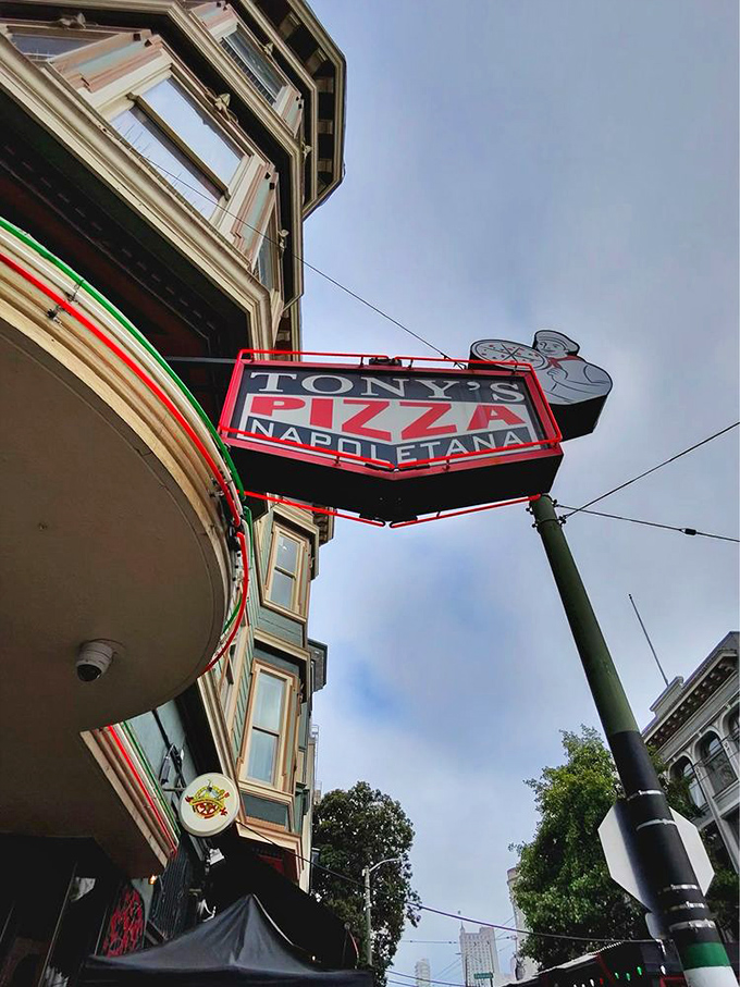The neon sign that's guided countless hungry pilgrims to pizza salvation. It's the North Star for those navigating San Francisco with empty stomachs.