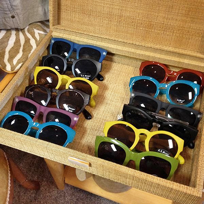 Vintage sunglasses organized like a rainbow of cool. Elton John would need a second home just to store this collection.