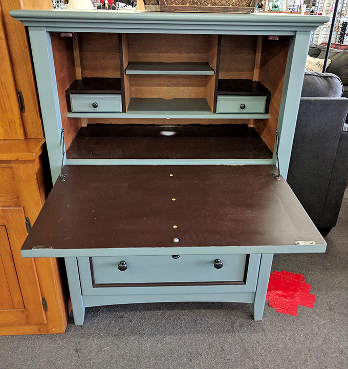 This charming secretary desk in soothing blue-gray reveals hidden compartments and possibilities. Vintage craftsmanship meets modern upcycling potential.