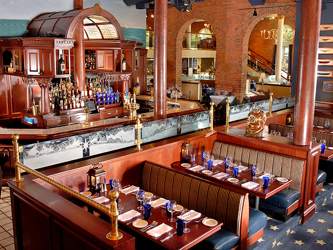 Rich wood booths and cobalt blue accents create dining spaces that feel both grand and intimate&mdash;like dining in a luxury liner.