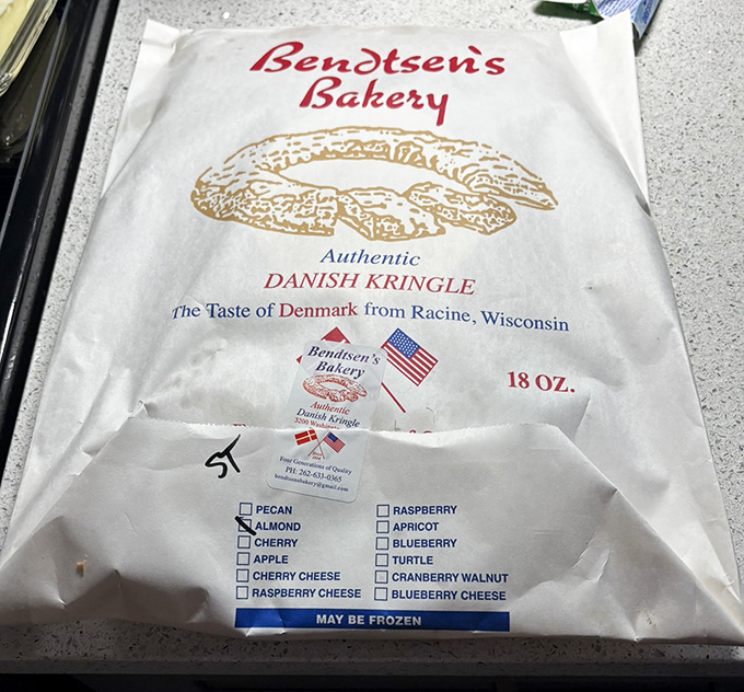 The to-go packaging proudly announces its contents like a passport &ndash; "Authentic Danish Kringle" is the best souvenir from Wisconsin.
