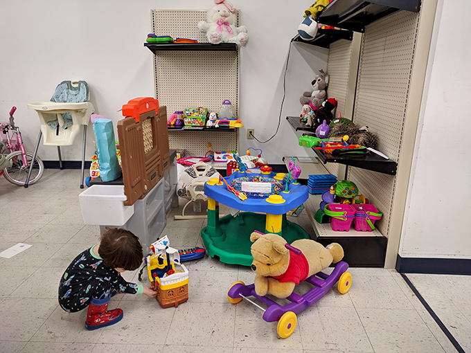 Childhood joy corner: where a little explorer discovers that secondhand toys come with first-rate imagination possibilities built right in.