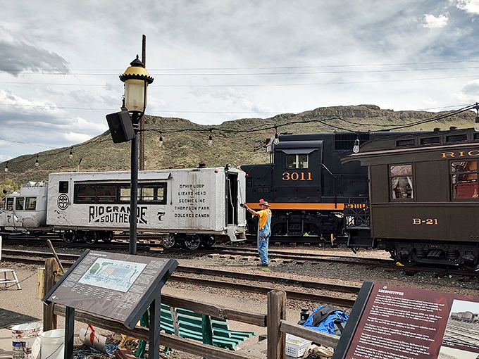 Where the past meets present&mdash;a volunteer in period costume brings railroad history to life against a backdrop of preserved rolling stock.