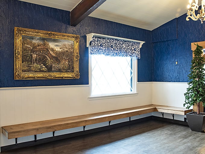 Blue walls, classic artwork, and bench seating – the waiting area that makes the anticipation of pancakes part of the whole delicious experience.