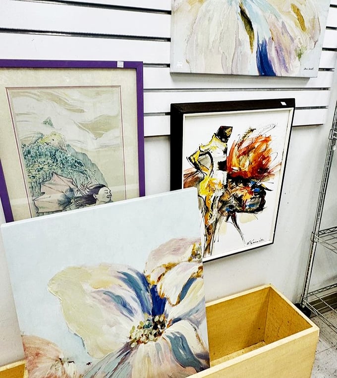 An art collector's dream corner where original paintings find second homes. That abstract piece might be worth more than your entire shopping trip.
