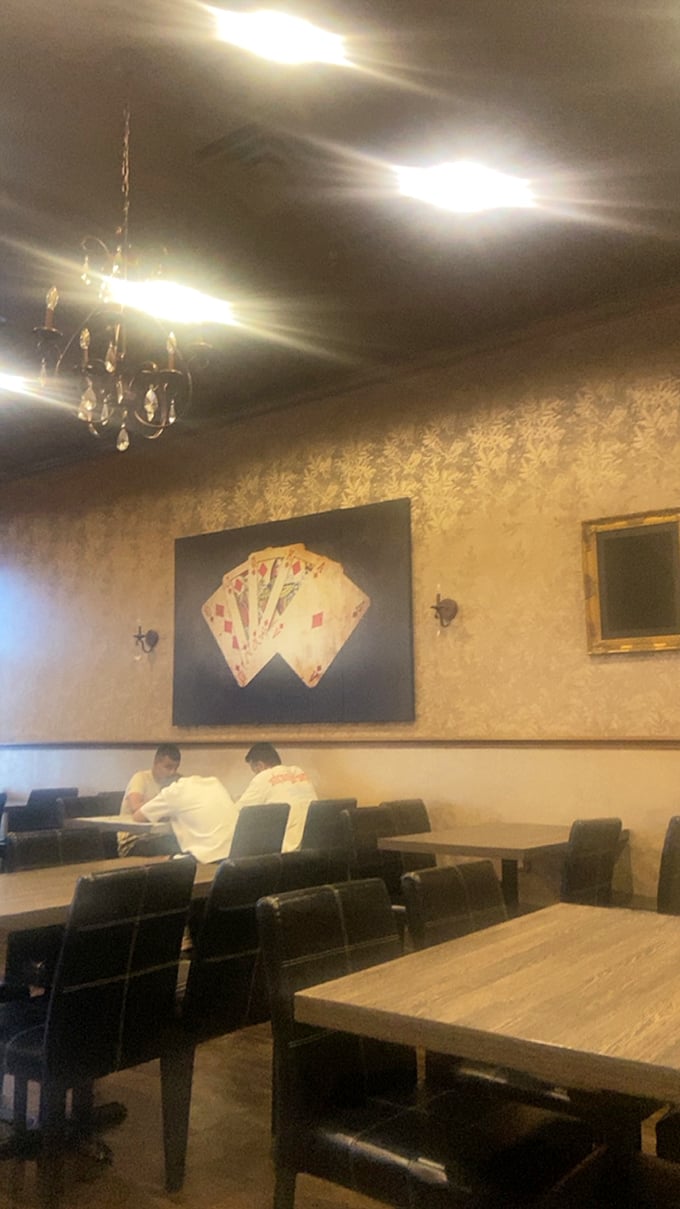 The playing card artwork nods to the "magic" theme while diners focus on the real sorcery happening on their plates.