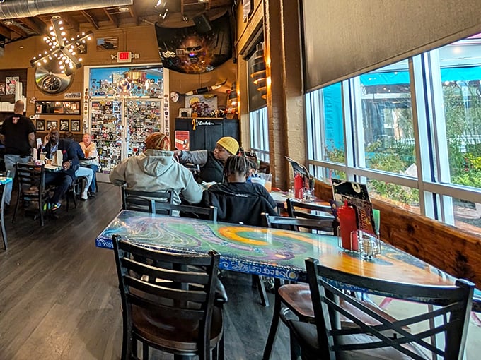 The natural light streaming through these windows illuminates more than just colorful tables – it spotlights a gathering place where memories are made between bites.